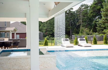 What is a rain curtain water feature on a swimming pool?